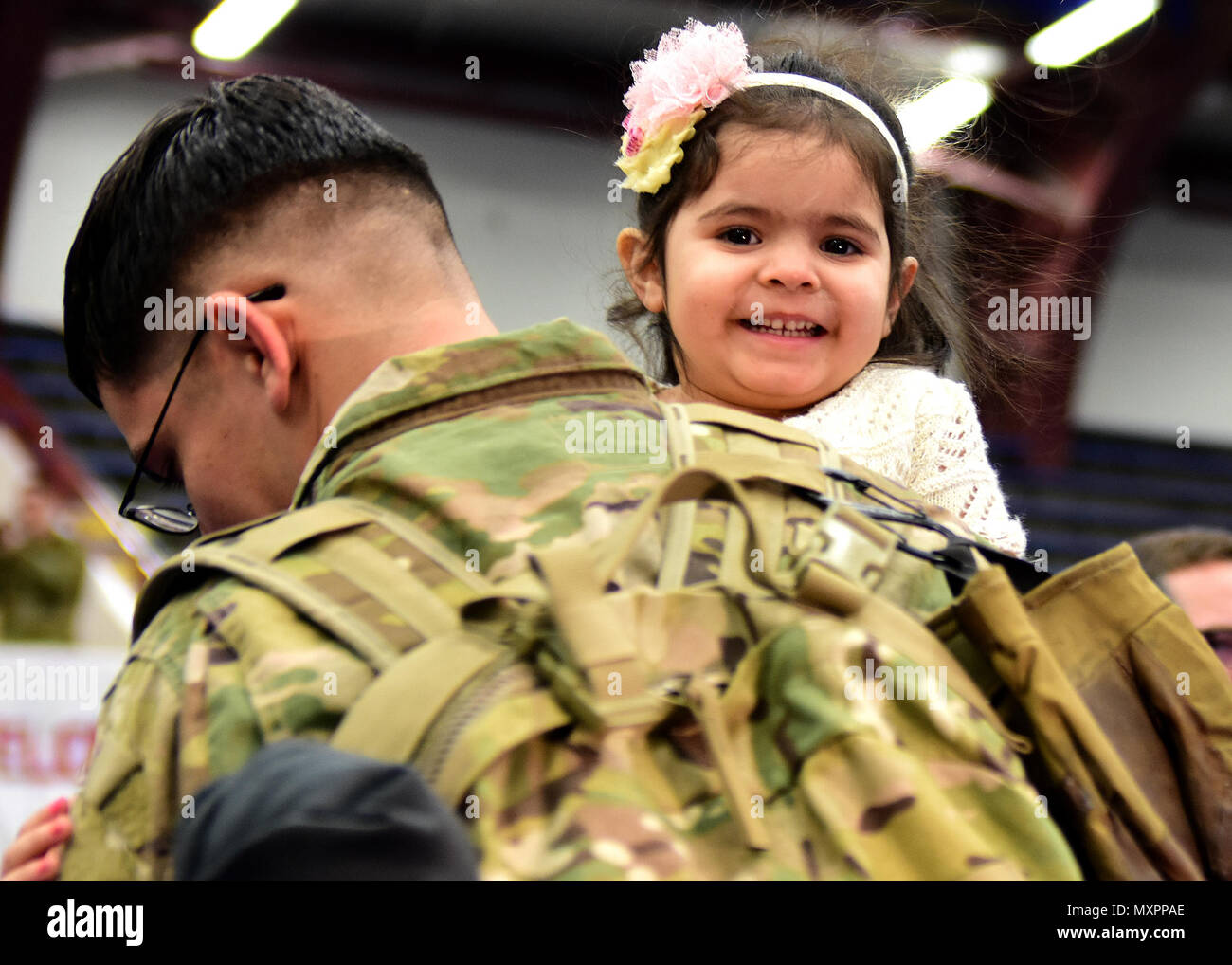Trinity Kelley, 3, is all smiles because her father, Spc. Christopher ...