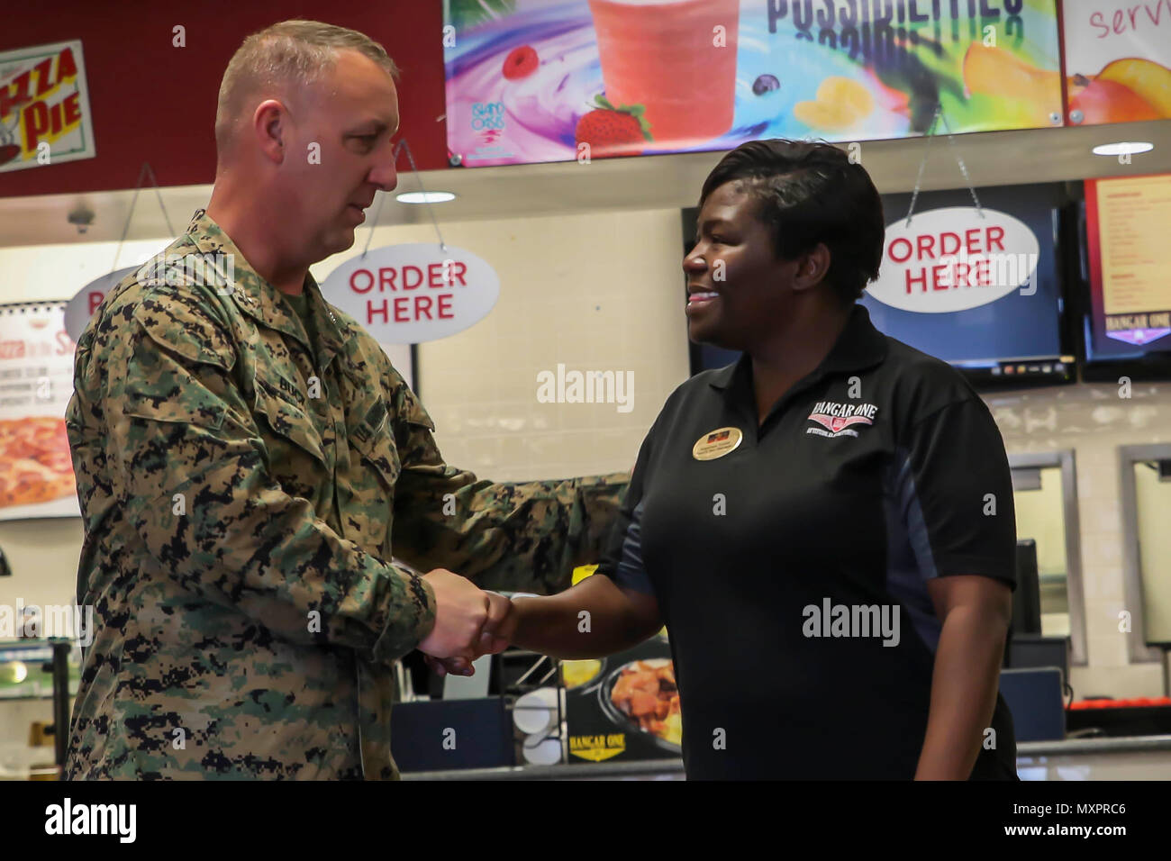Col. Peter D. Buckcongratulates Angelique Jacobs-Tucker after ...