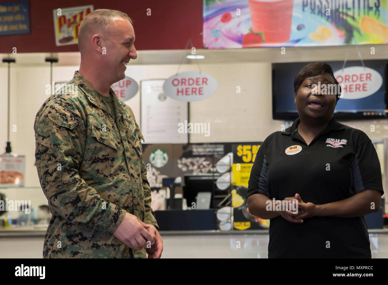 Col. Peter D. Buck shares a laugh with Angelique Jacobs-Tucker after ...