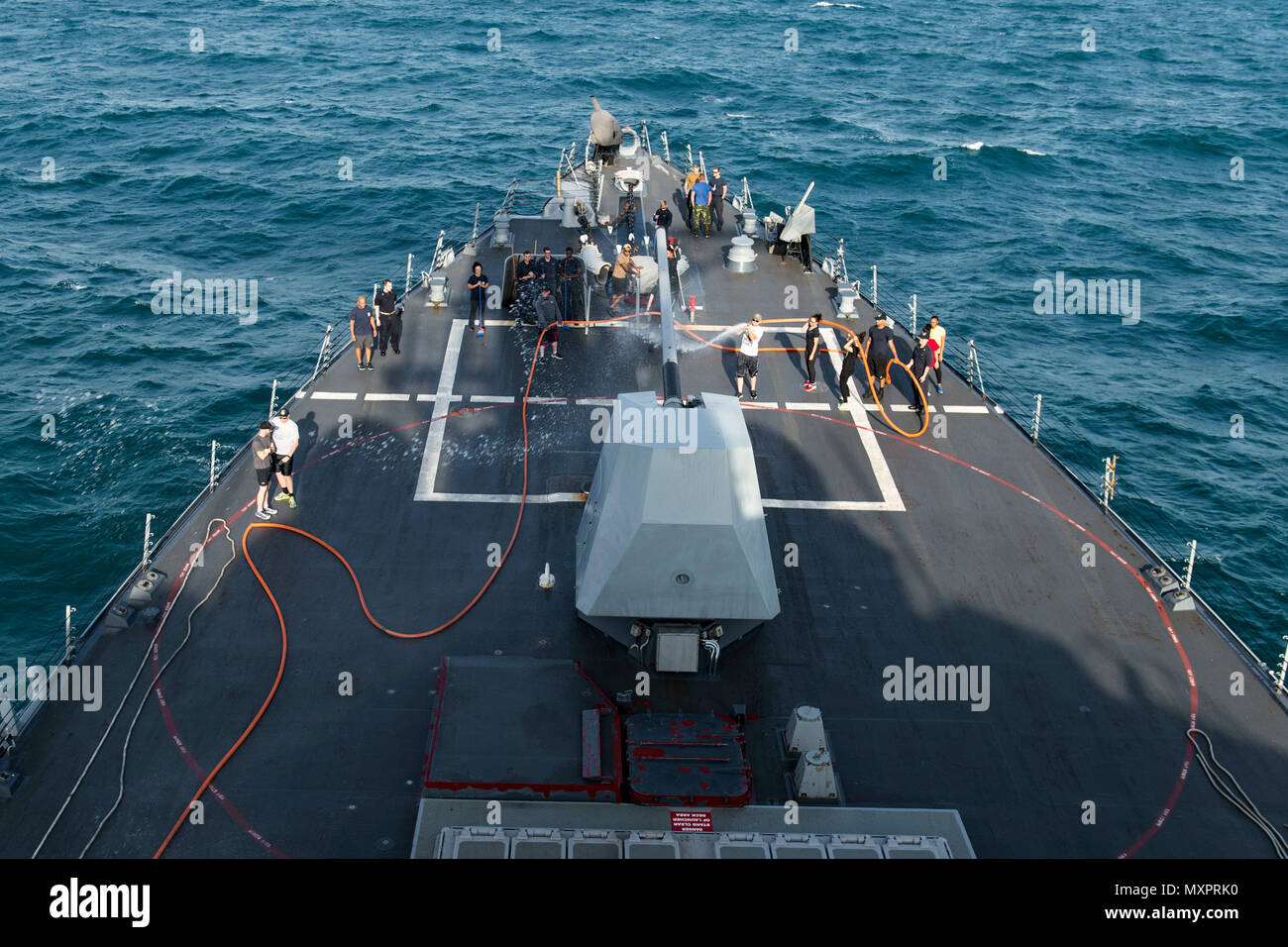 Sailors aboard the guided-missile destroyer USS Nitze (DDG 94) perform ...