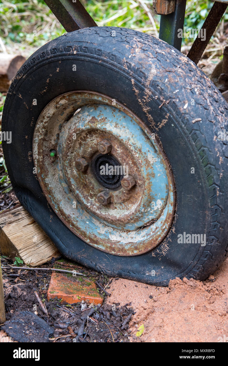 Old wheel of a car flat and rusty Stock Photo - Alamy