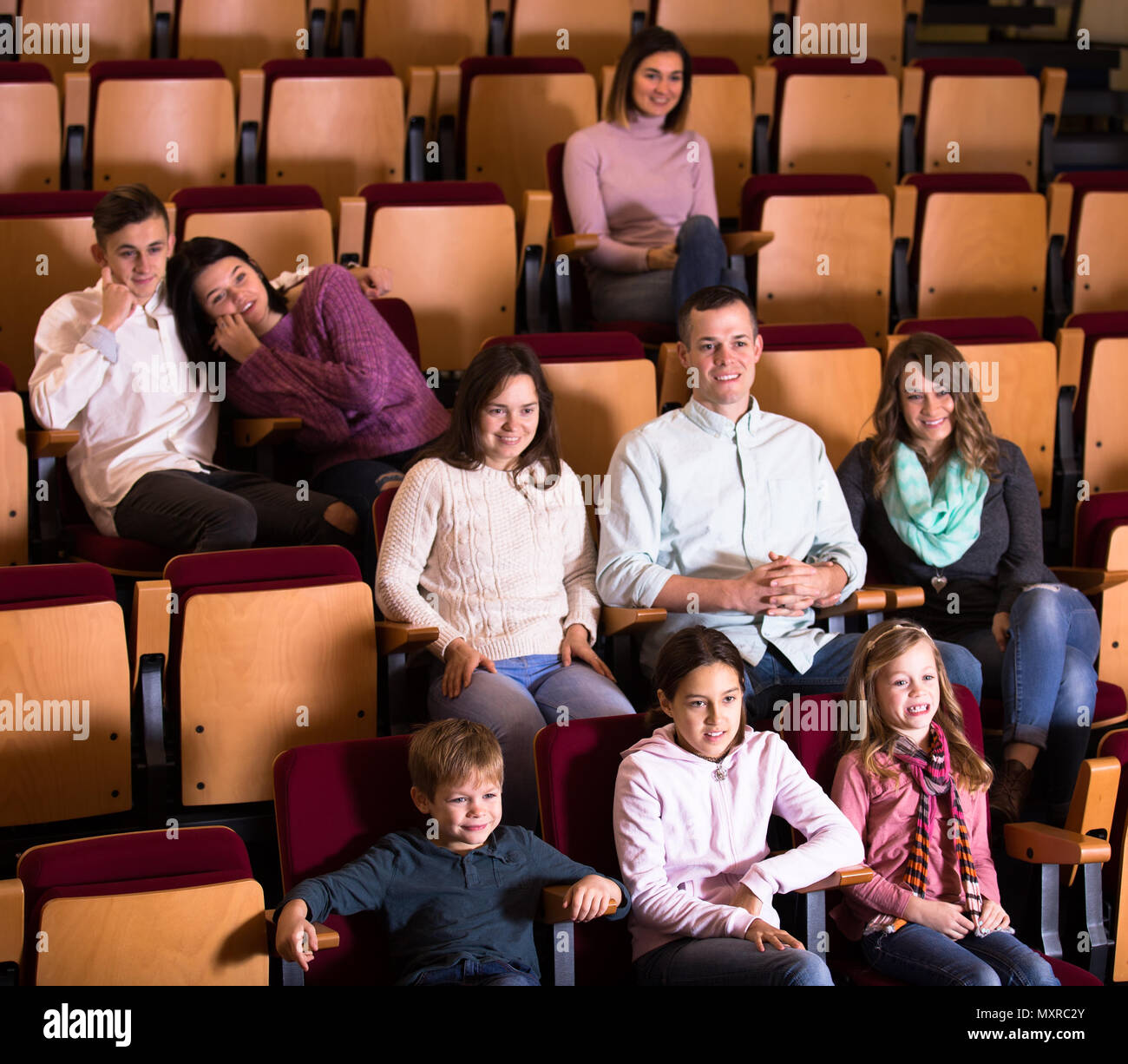 Spectators attending movie night in cinema house Stock Photo - Alamy