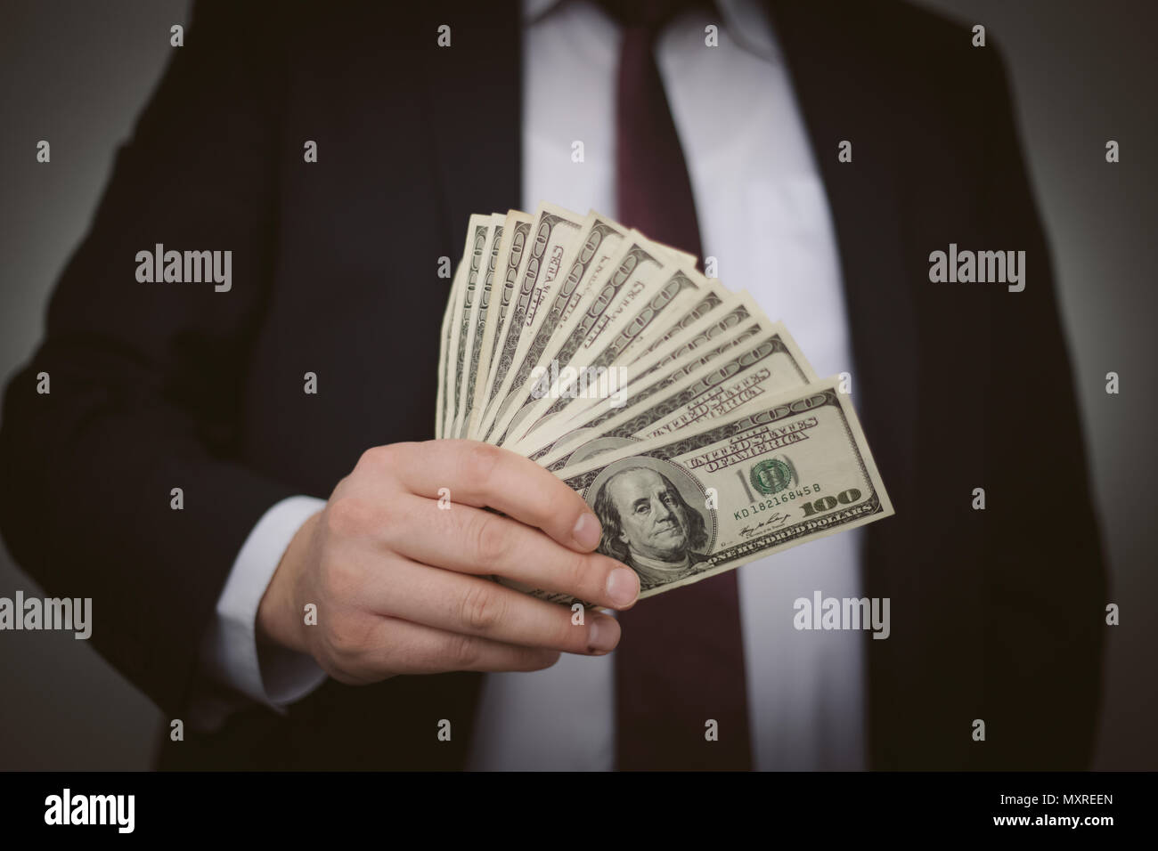 Business Man Displaying a Spread of Cash over a white vintage ...