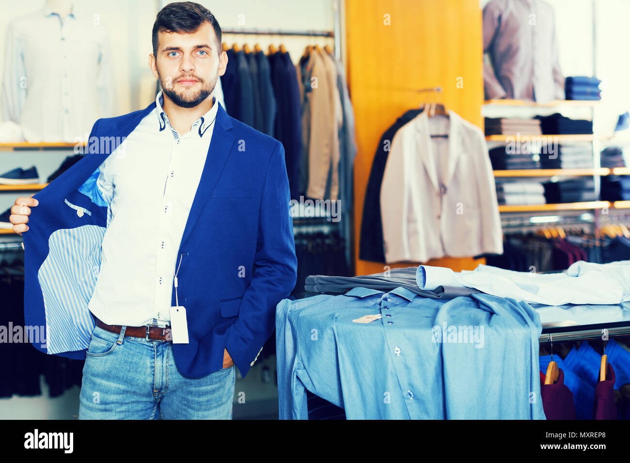 male buyer shows off his jacket at a men's store Stock Photo - Alamy