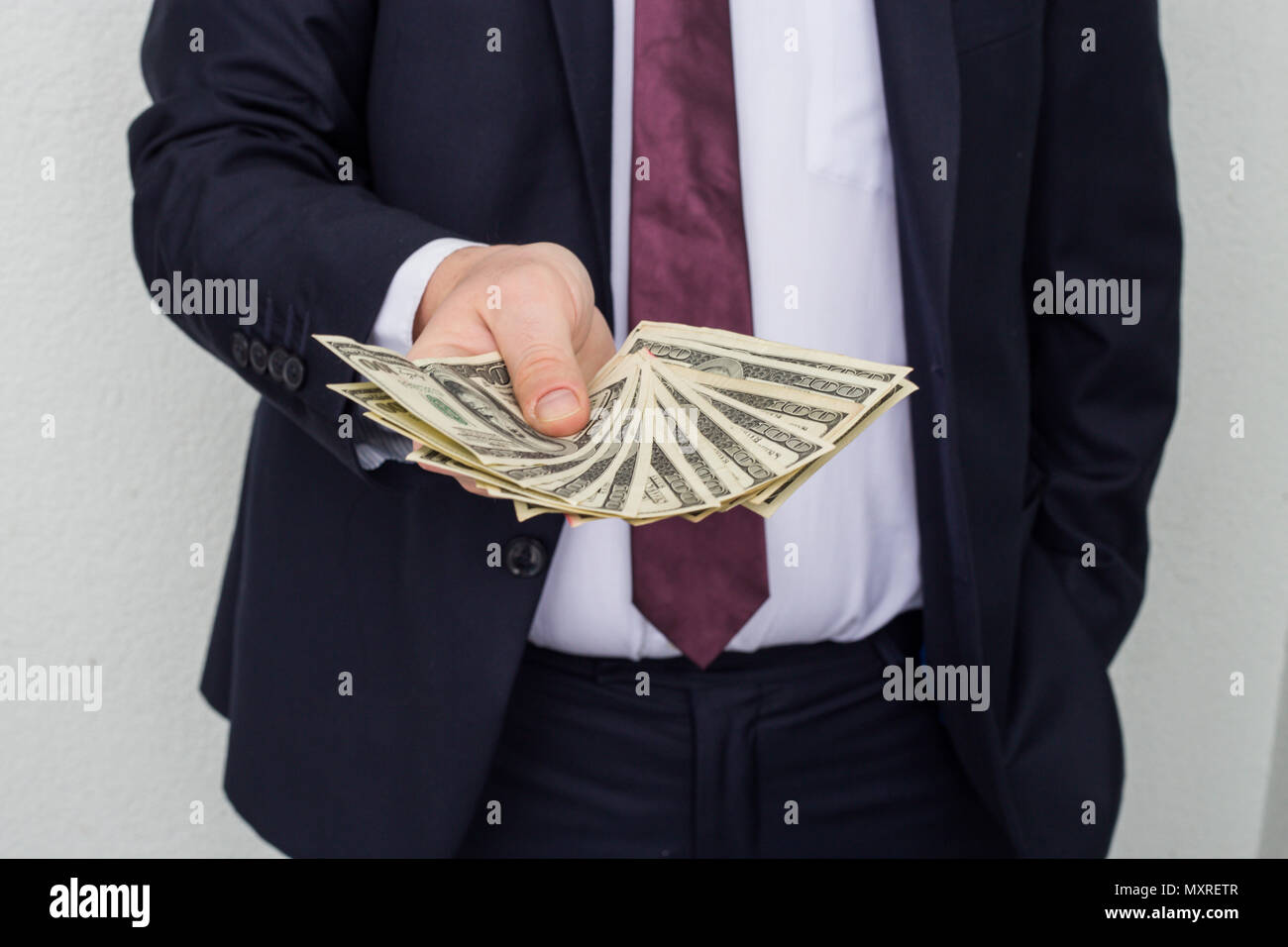Business Man Displaying a Spread of Cash over a white vintage ...