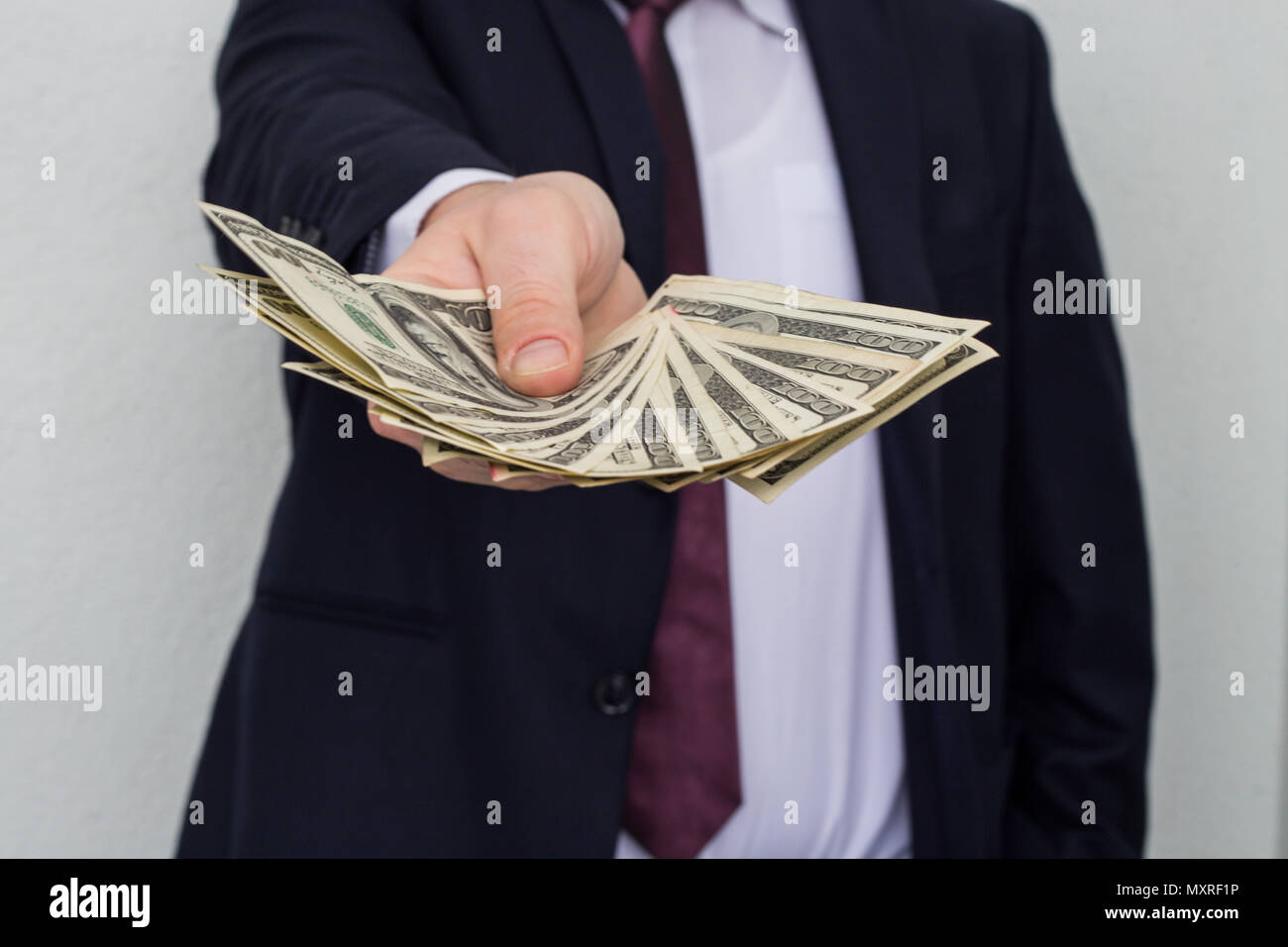 Business Man Displaying a Spread of Cash over a white vintage ...
