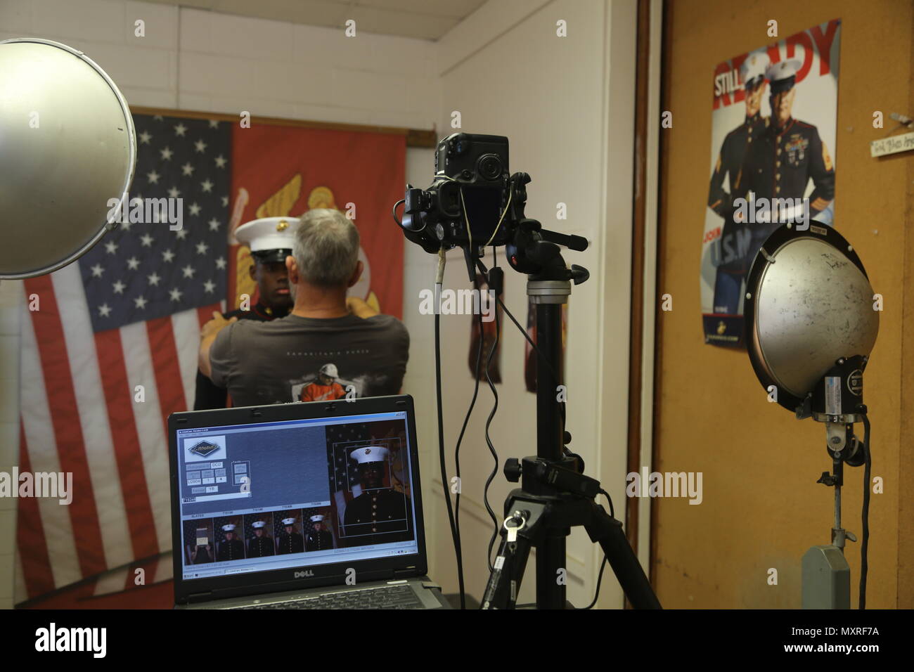 Dennis Murphy, a Recruit Photographer, adjusts a U.S. Marine Corps ...