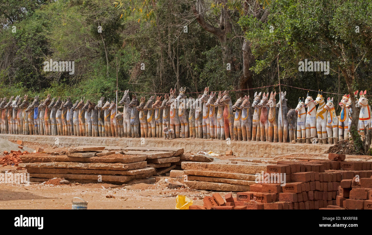 Clay horses assembled in homage to the Hindu god Ayyanar surrounding ...