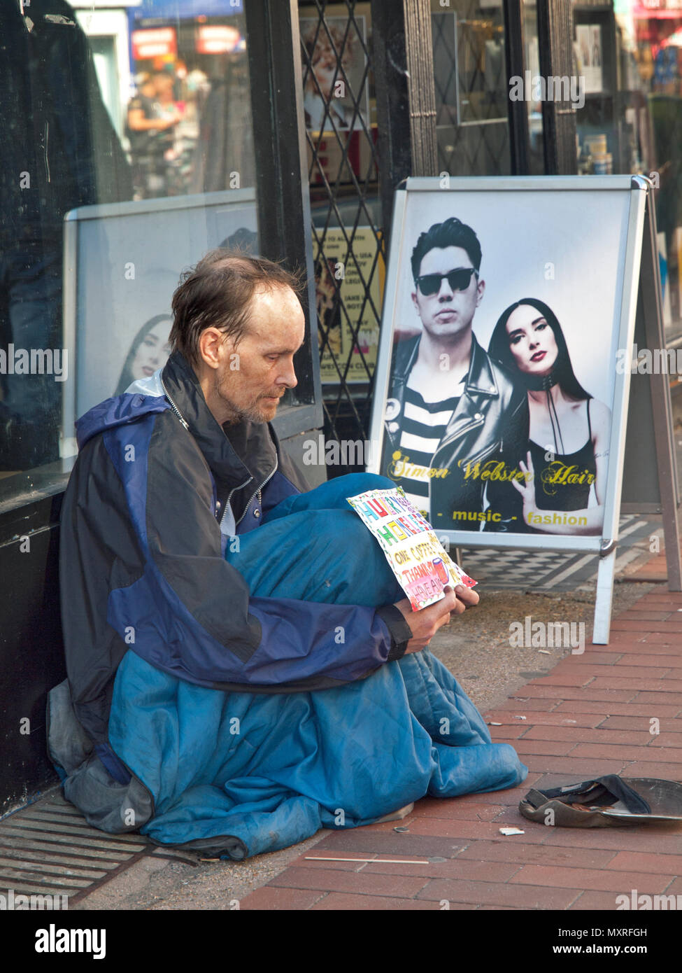 Homeless beggar on pavement in hi-res stock photography and images - Alamy