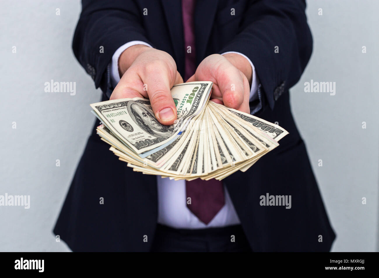 Business Man Displaying a Spread of Cash over a white vintage ...