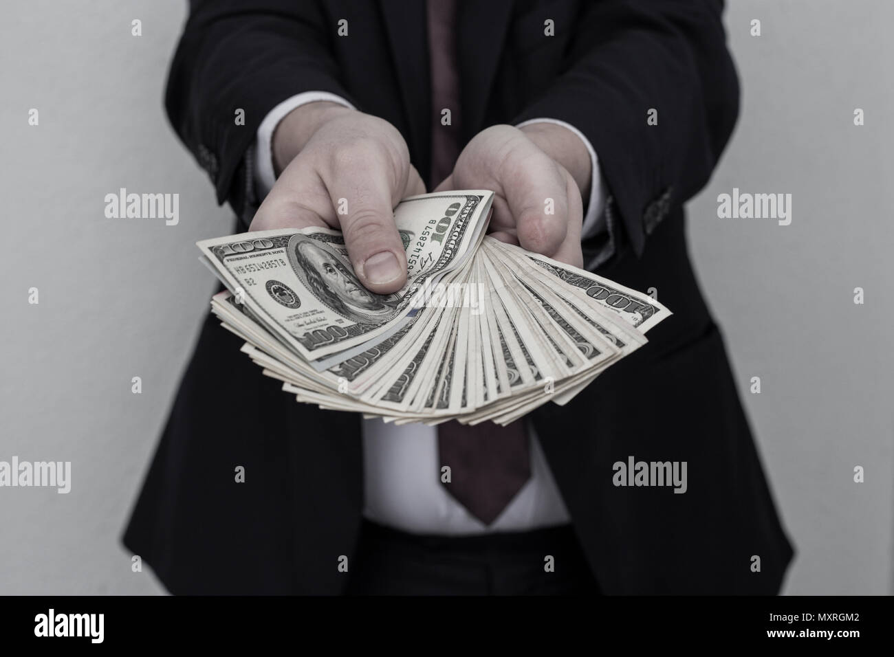 Business Man Displaying a Spread of Cash over a white vintage ...