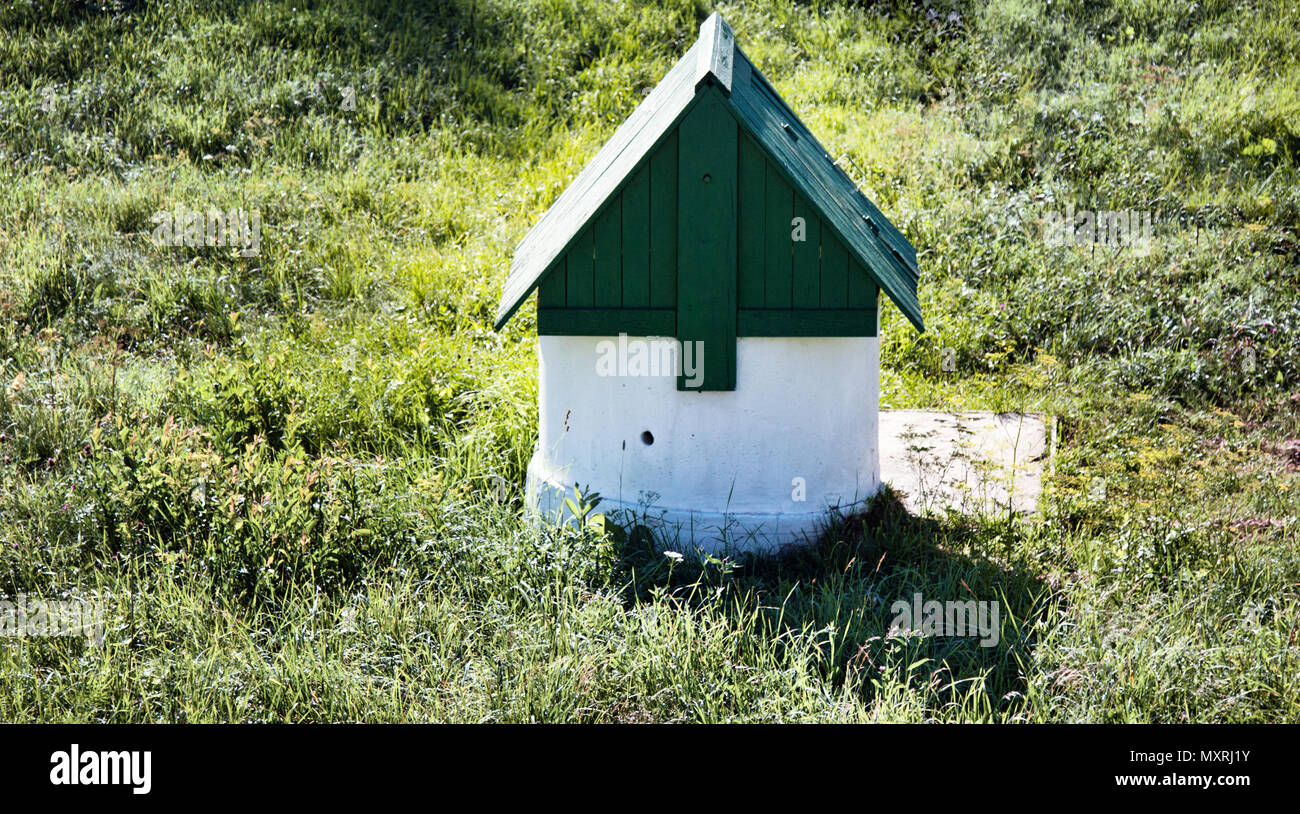 community well in Russian village in background of garden and poor ...