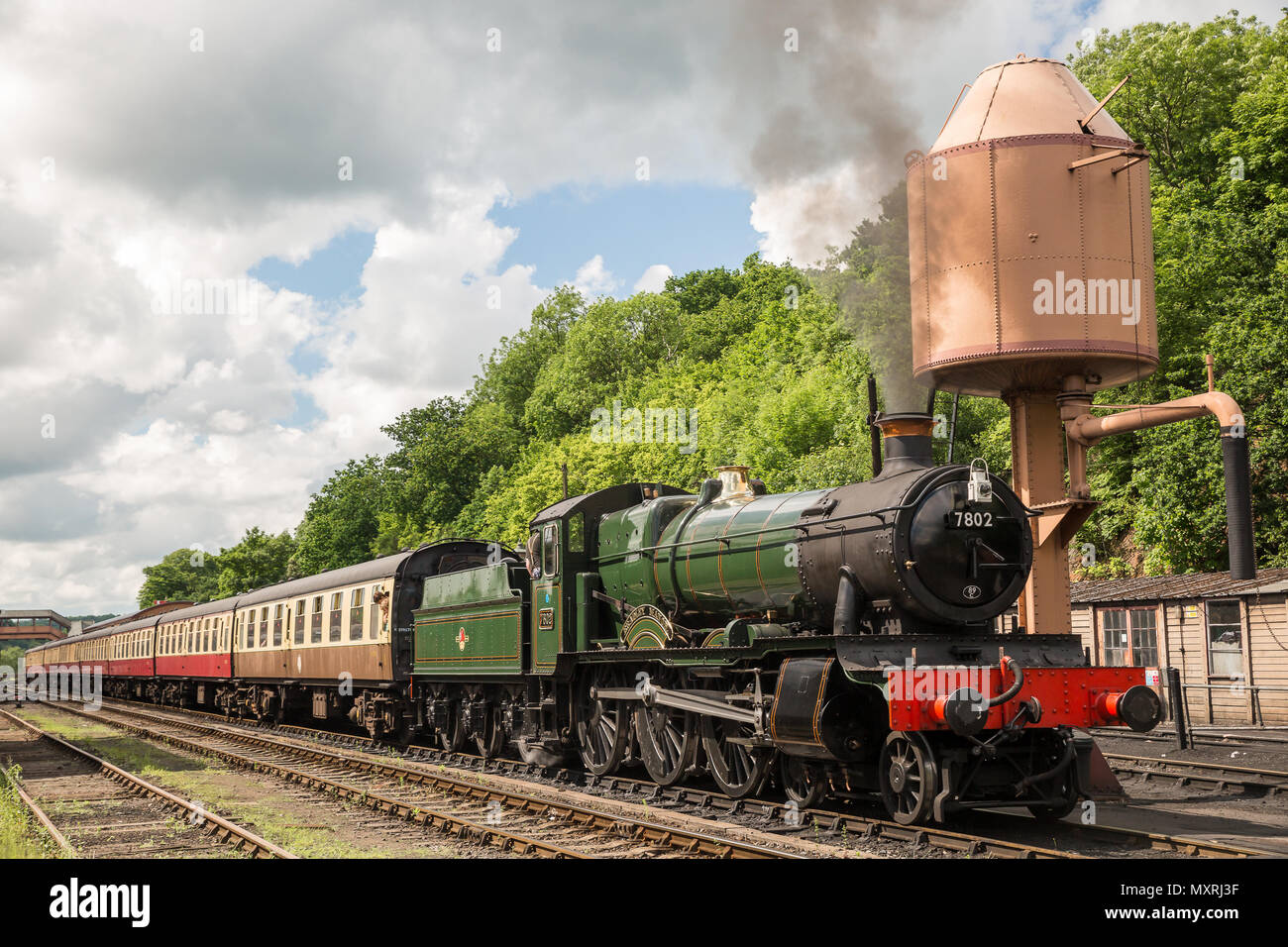Vintage UK steam train, front view, on railway track awaiting departure ...
