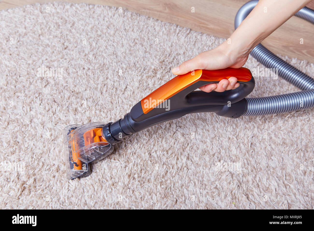 Crop person using handheld vacuum cleaner at home and washing soft ...