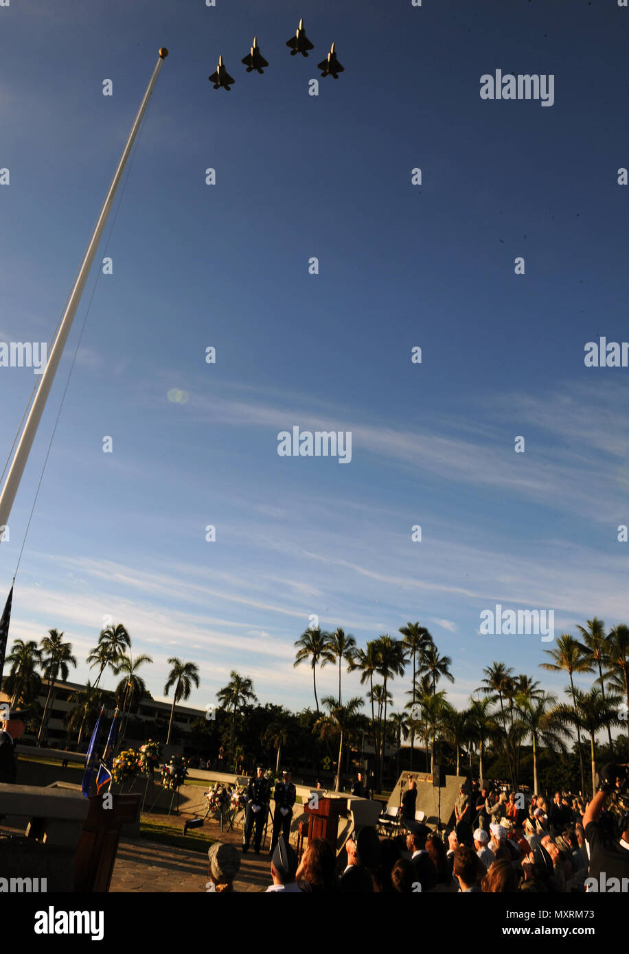 A formation of F-22 Raptors perform a flyover above the 75th ...