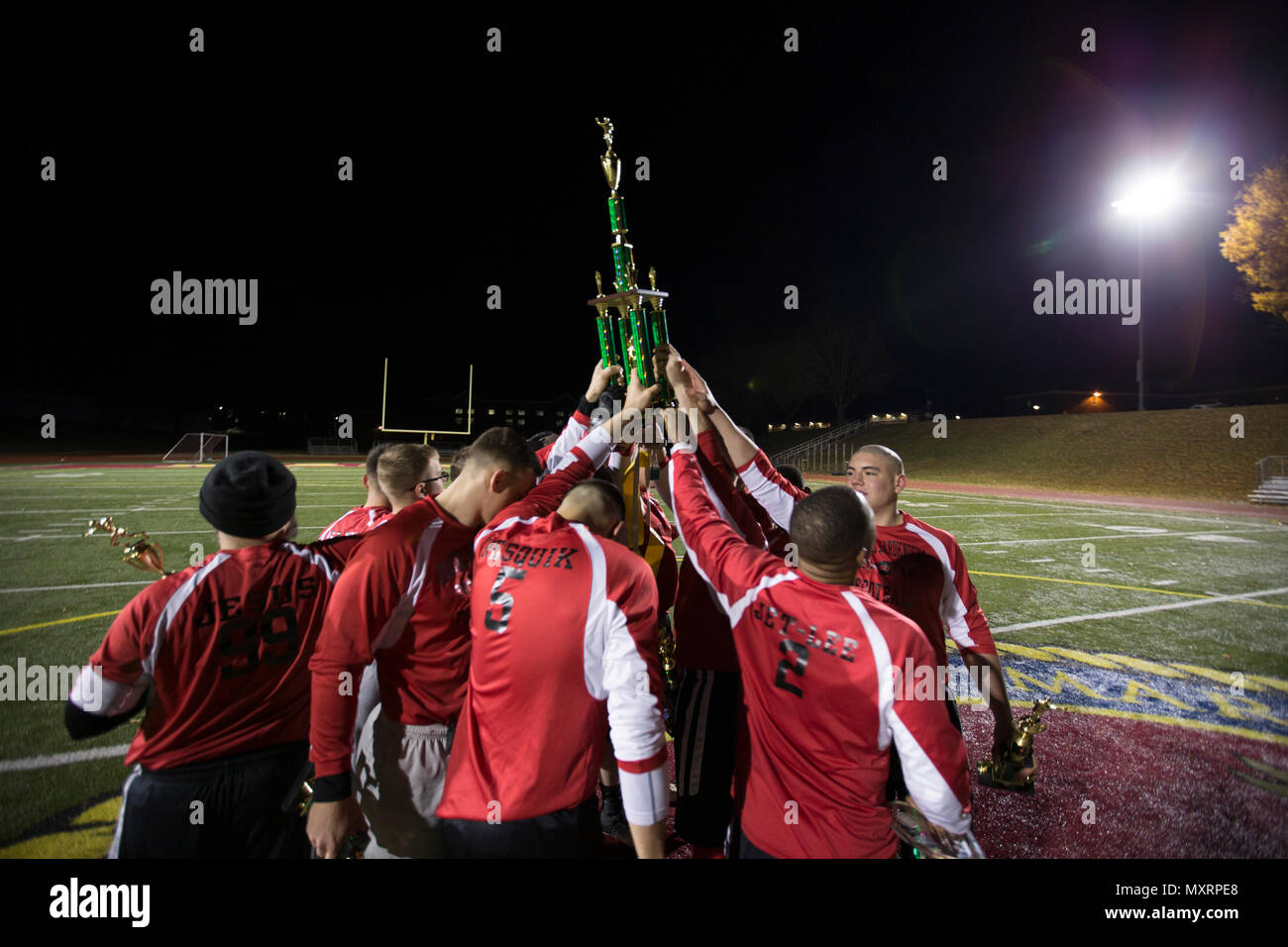 U.S. Marines with the Base Motor Transport flag football team raise the ...