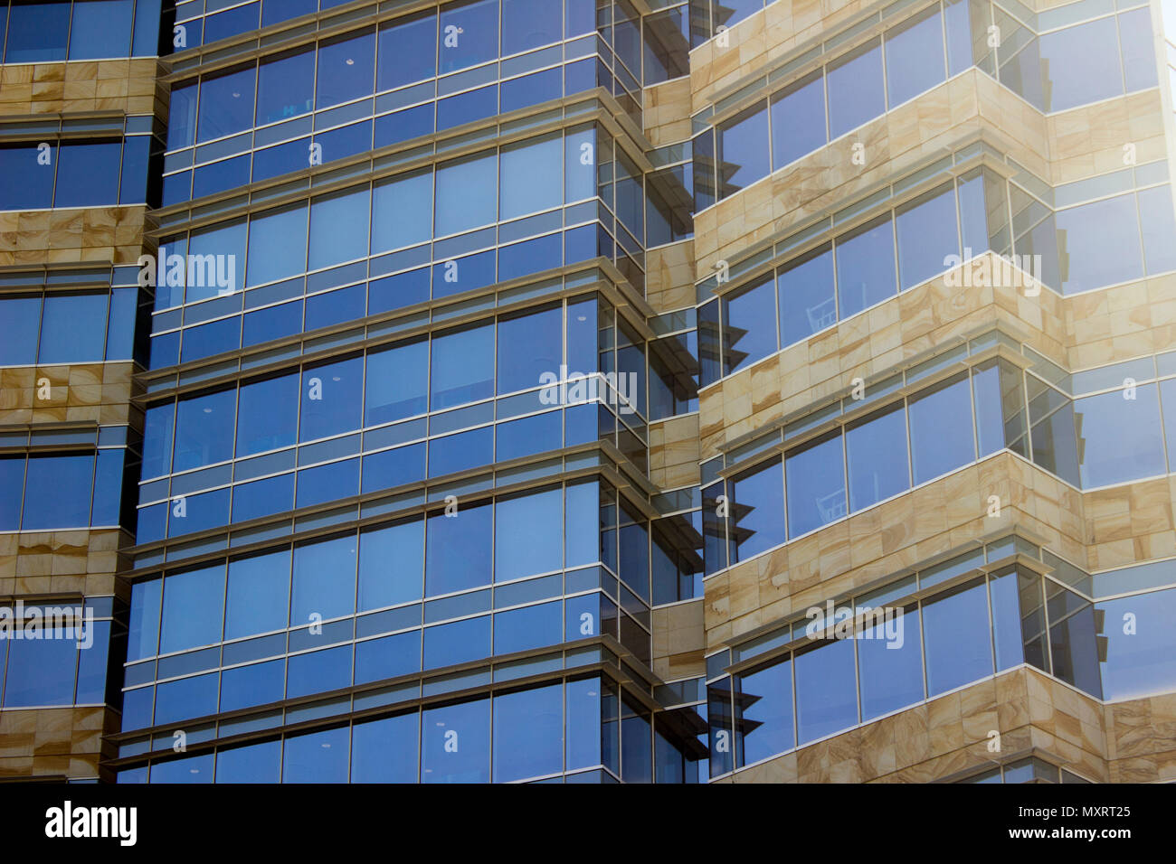 Side view of a corporate building façade made of glass windows and ...