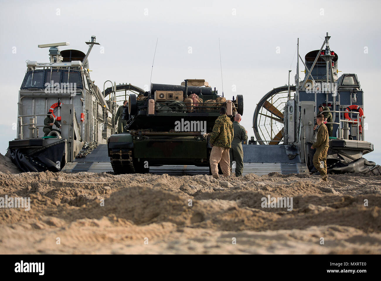 A M1A1 Abrams tank unloads from a landing craft air cushion hovercraft ...