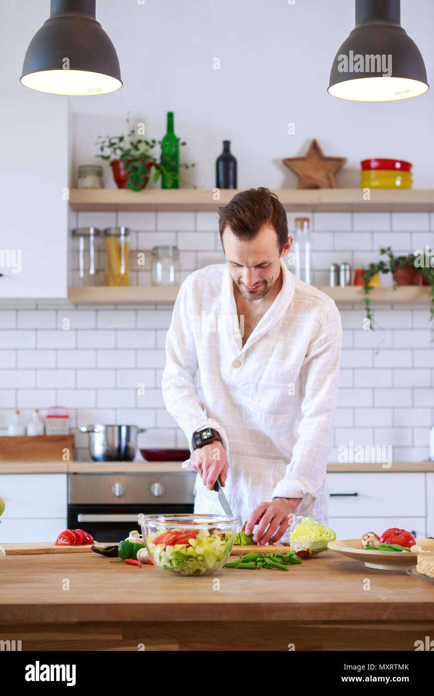 Image of man cooking dinner on table Stock Photo - Alamy