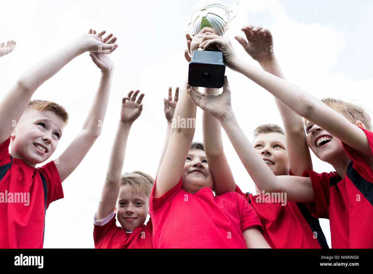Junior Team Holding Trophy Stock Photo - Alamy