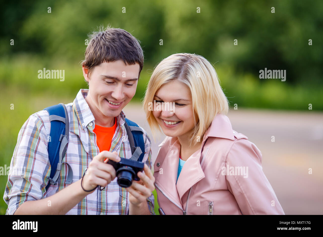 Man and woman looking photos at camera Stock Photo - Alamy