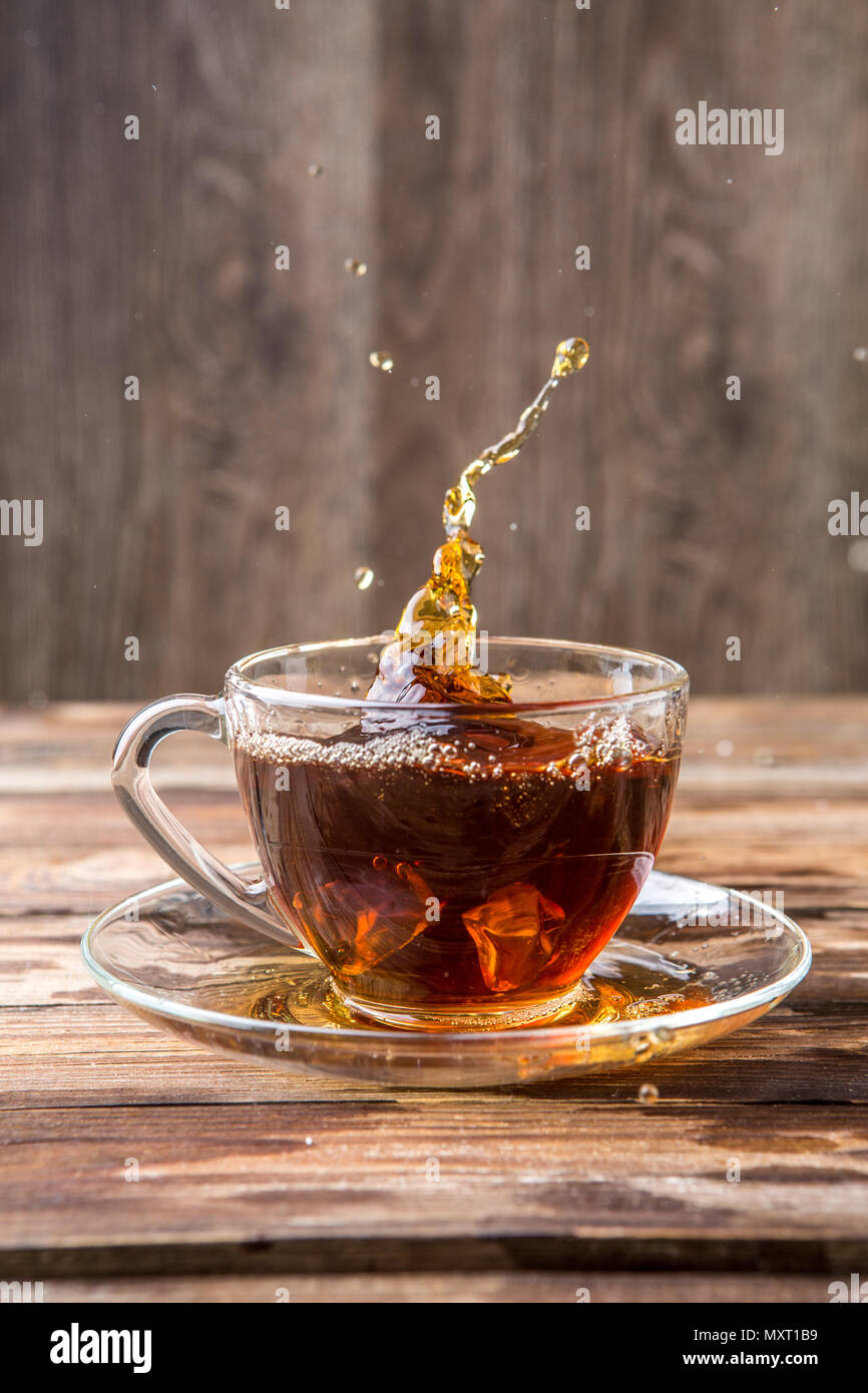 Spill tea in transparent mug Stock Photo - Alamy