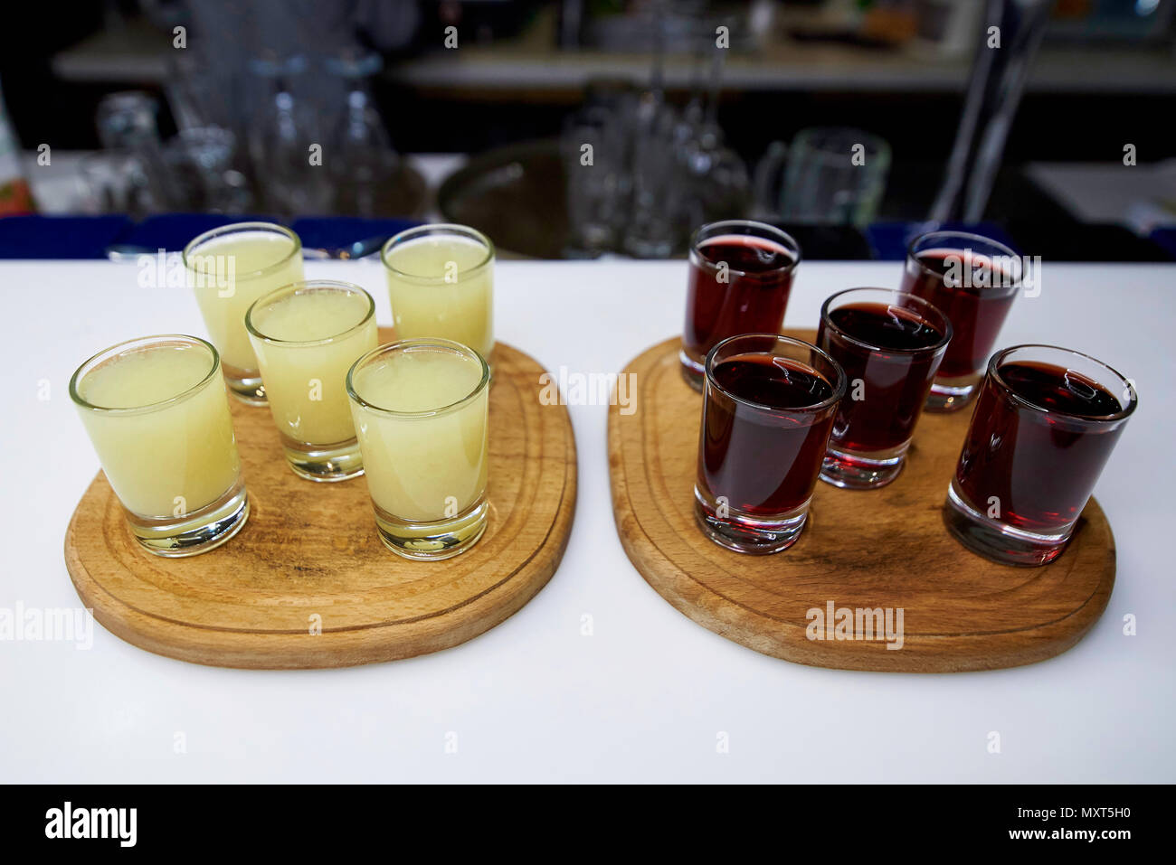 Alcohol shots on a wooden tray stand on the bar counter Stock Photo - Alamy