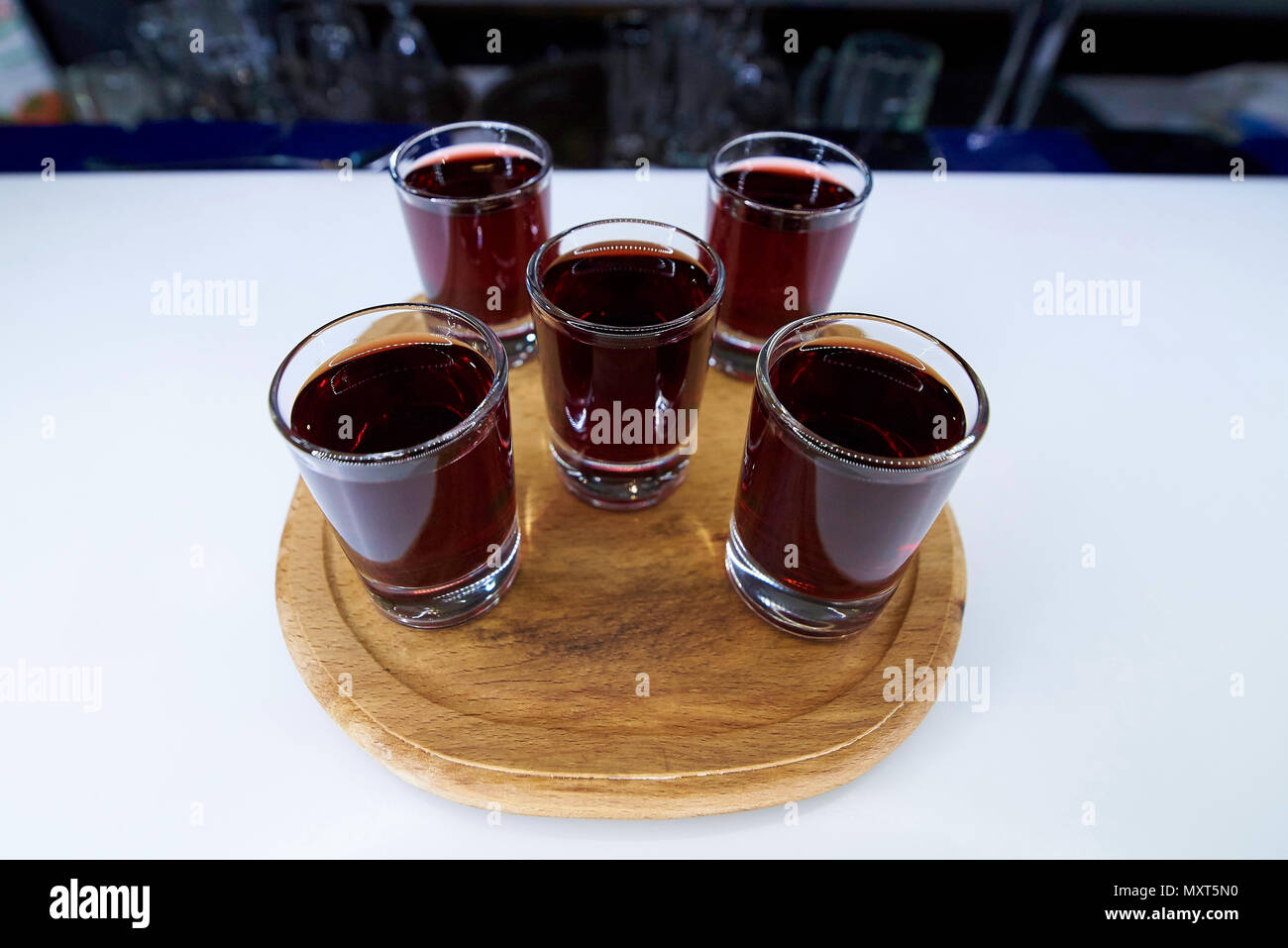 Alcohol shots on a wooden tray stand on the bar counter Stock Photo - Alamy