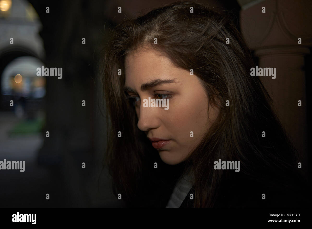 Profile view of a young western woman in deep thought Stock Photo - Alamy