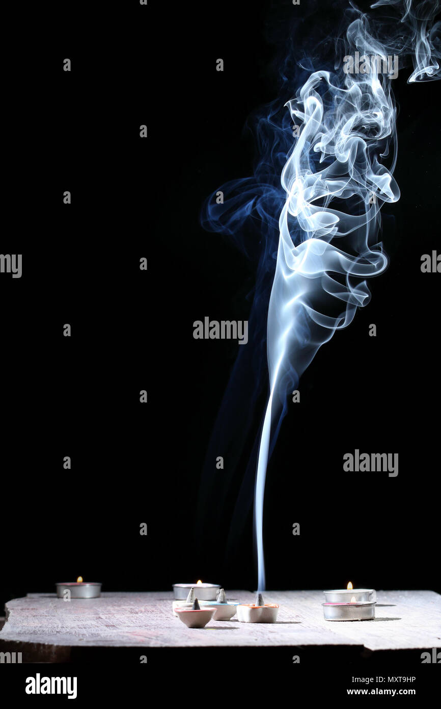 Incense cone or gum benjamin with abstract smoke, black background ...