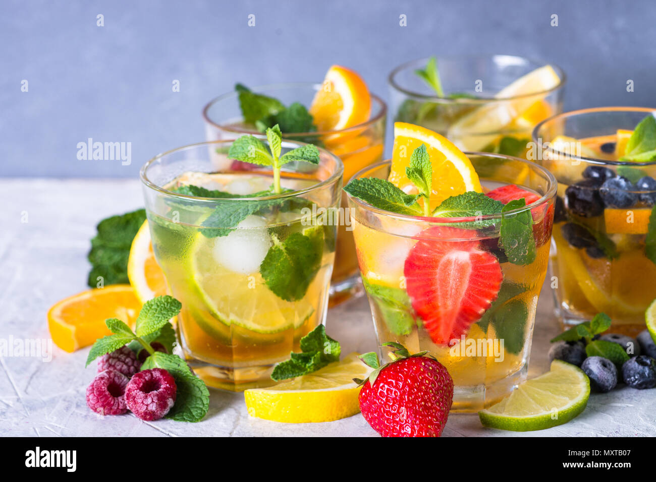 Lemonade set. Lemonade, mojito and berry lemonade in glasses on stone ...