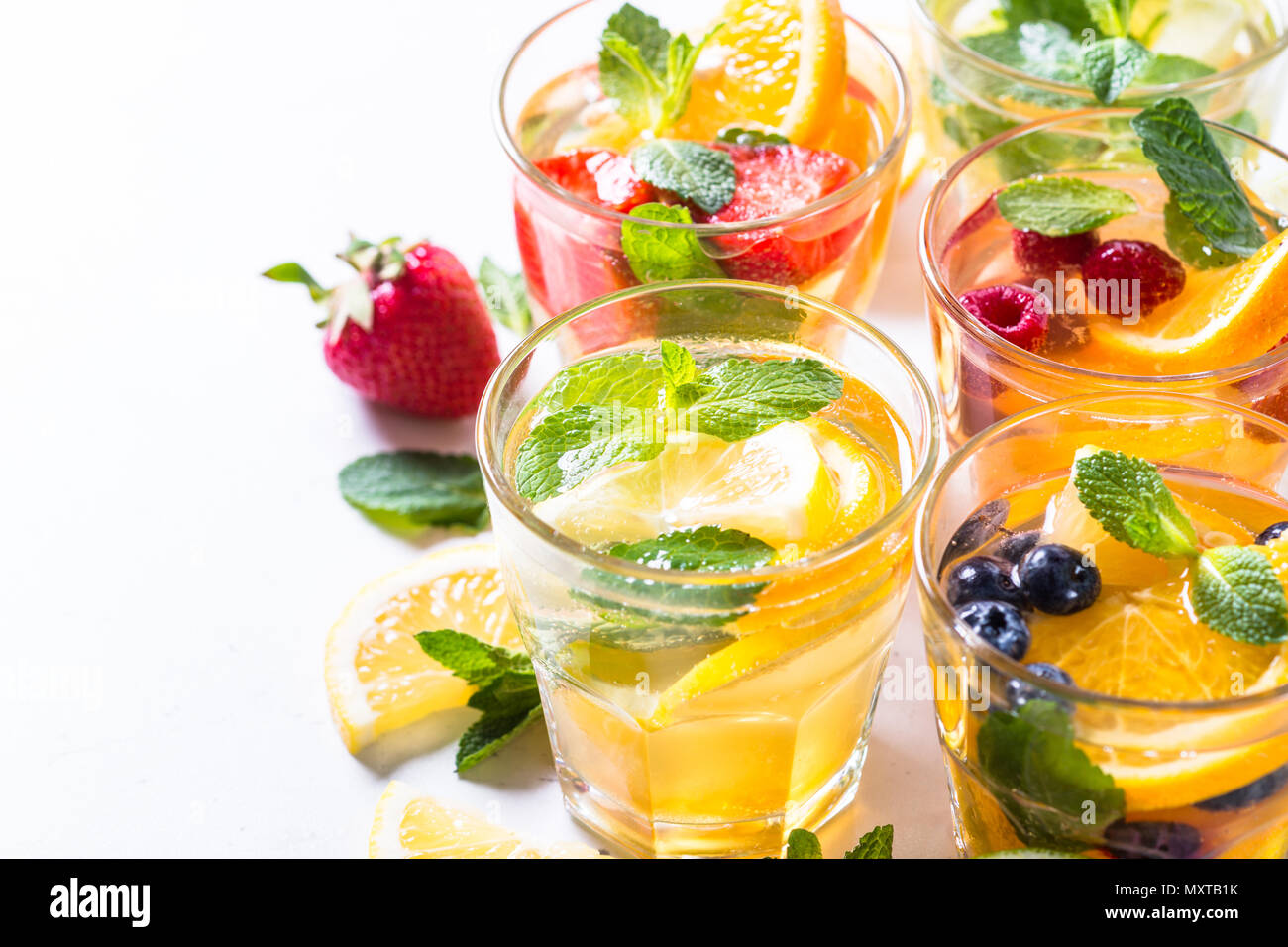 Lemonade set. Lemonade, mojito and berry lemonade in glasses on white ...