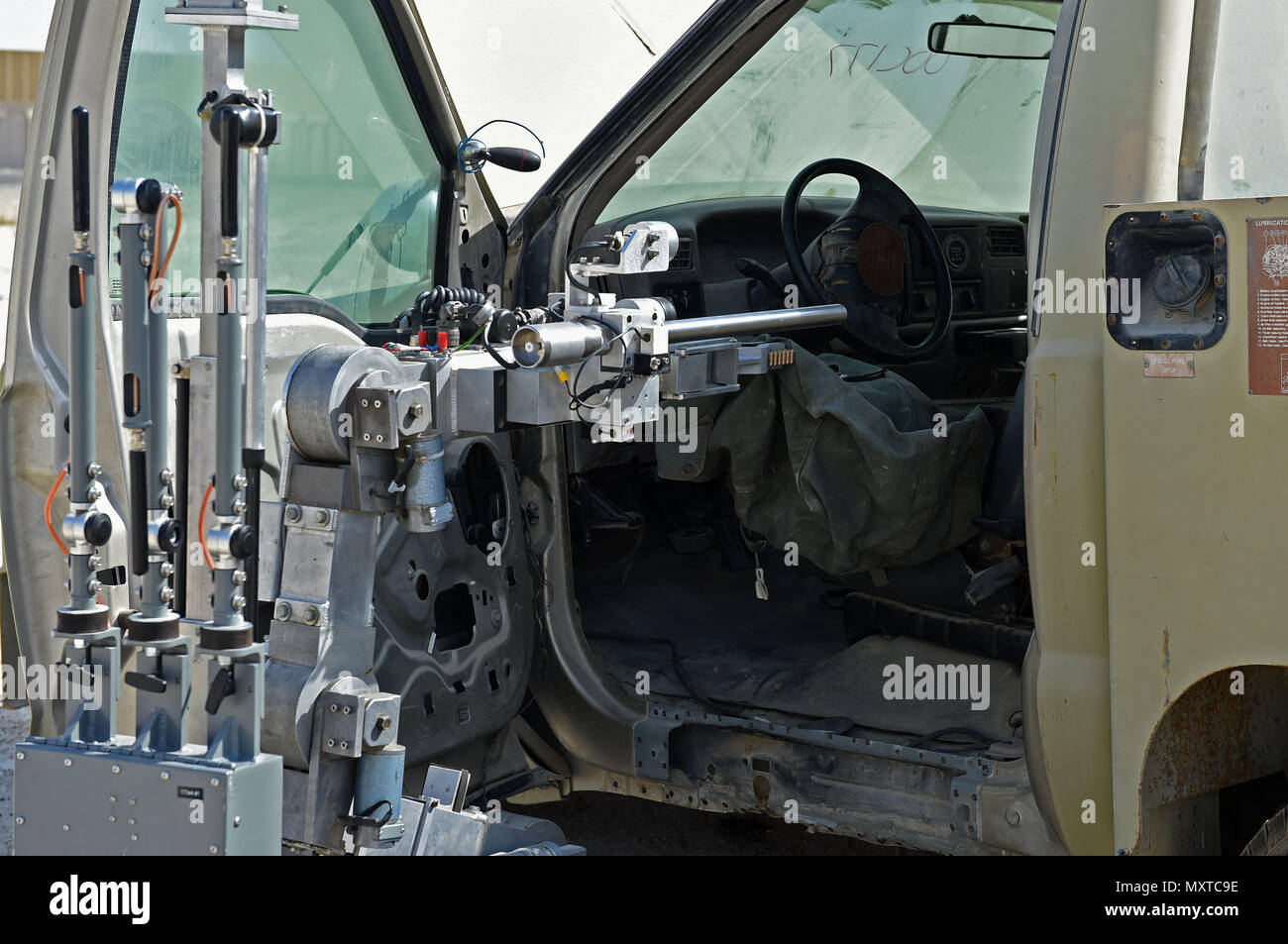 A 380th Expeditionary Explosive Ordnance technician uses a remotely ...