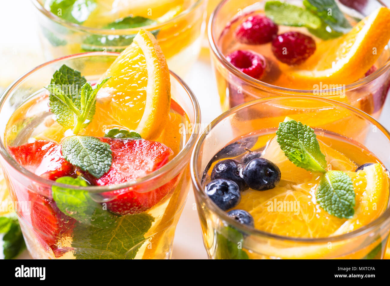 Lemonade set. Lemonade, mojito and berry lemonade in glasses on white ...