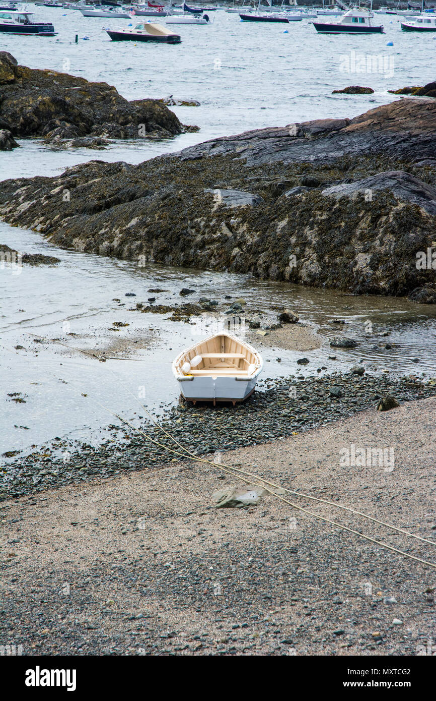 Low tide causes this small boat to beach itself on the rocks Stock ...