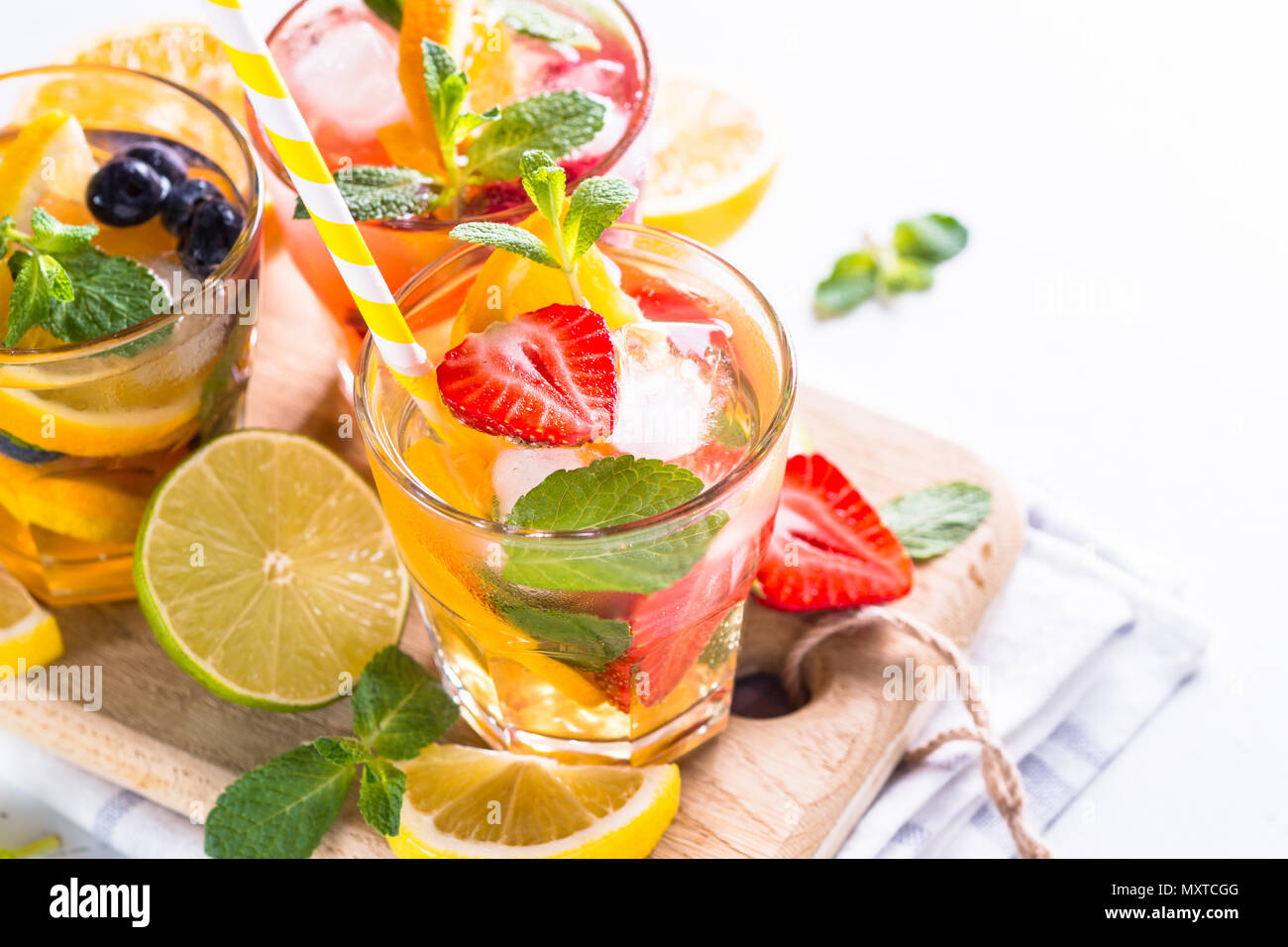 Summer drink assortment. Lemonade, mojito and strawberry lemonade in ...