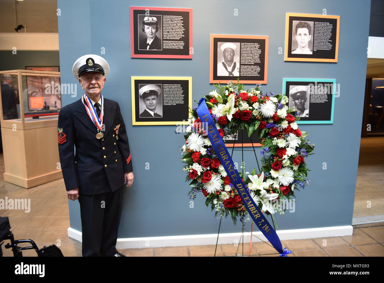 Pearl Harbor survivor Chief Frank Ruby, USN, stands next to his ...