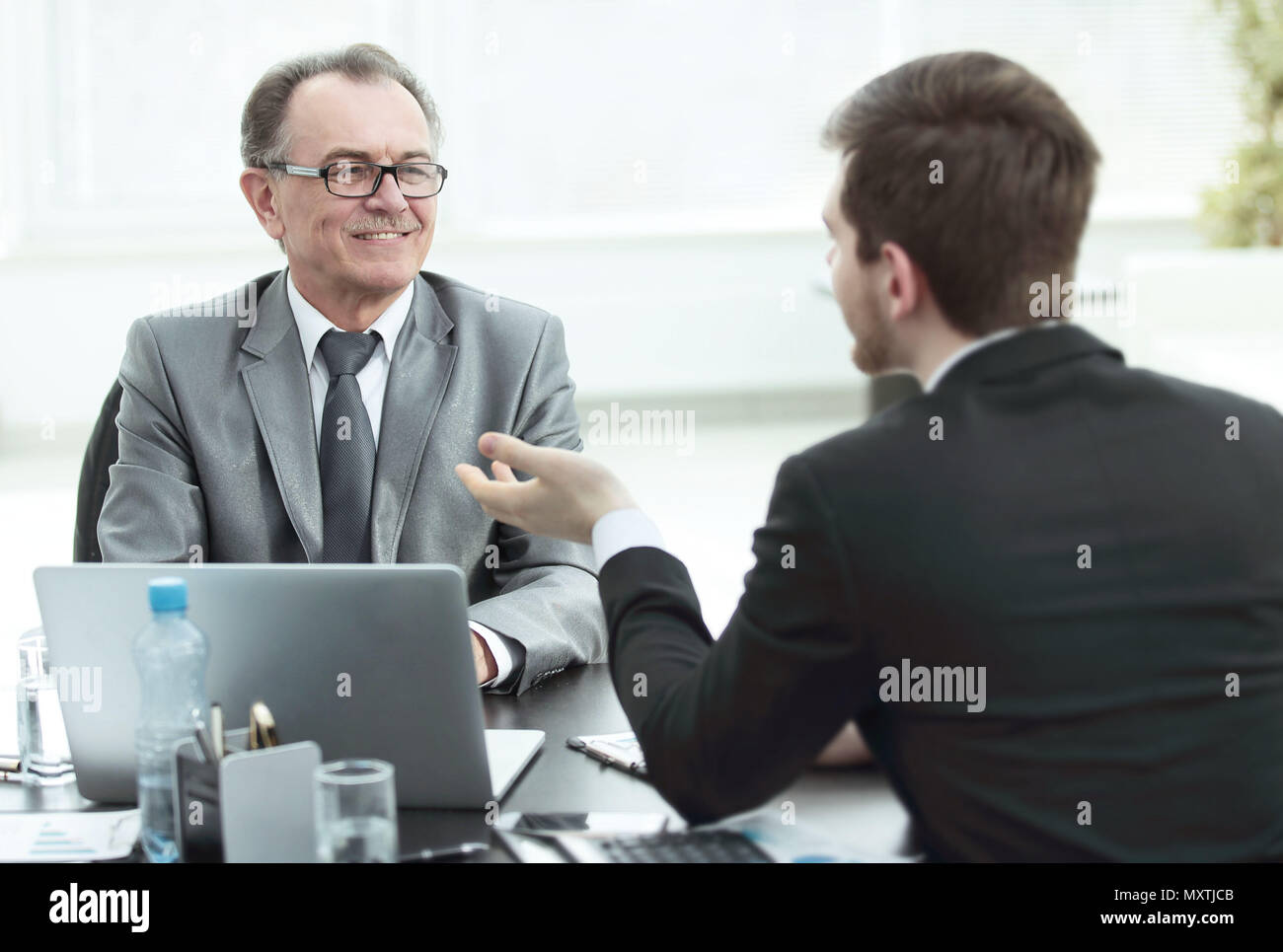 close up.business people talking at a Desk Stock Photo - Alamy