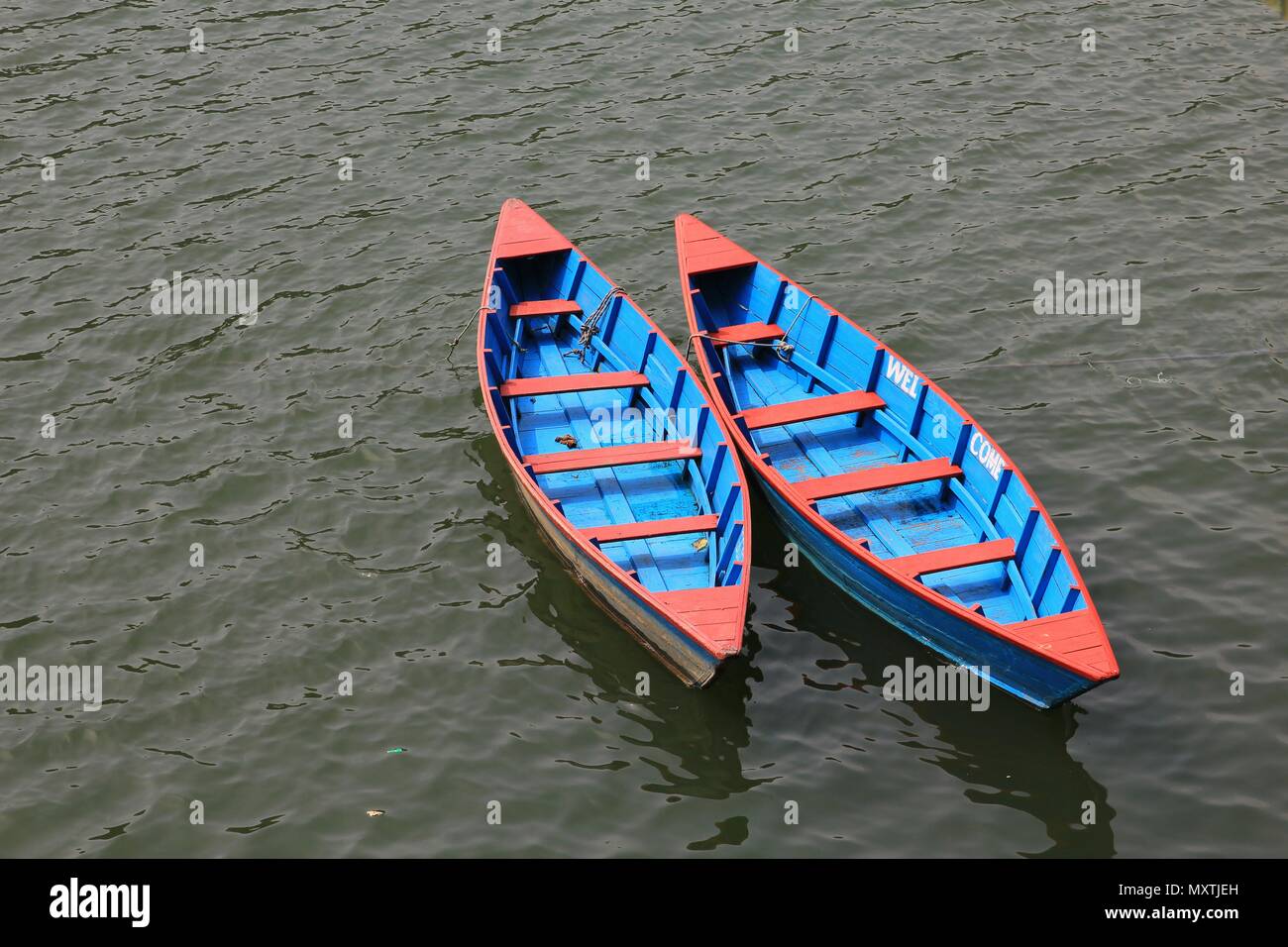 Beautiful timber rowing boats on Fewa lake, Nepal Stock Photo - Alamy