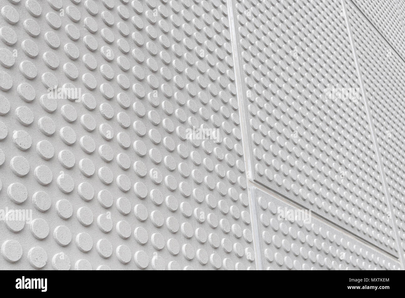 Textured wall in symetrical circular embossed shapes repeating, light ...