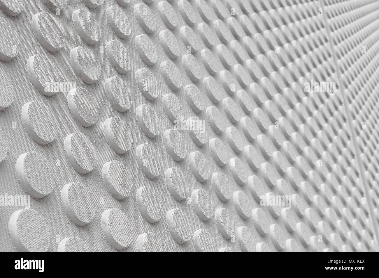 Textured wall in symetrical circular embossed shapes repeating, light ...