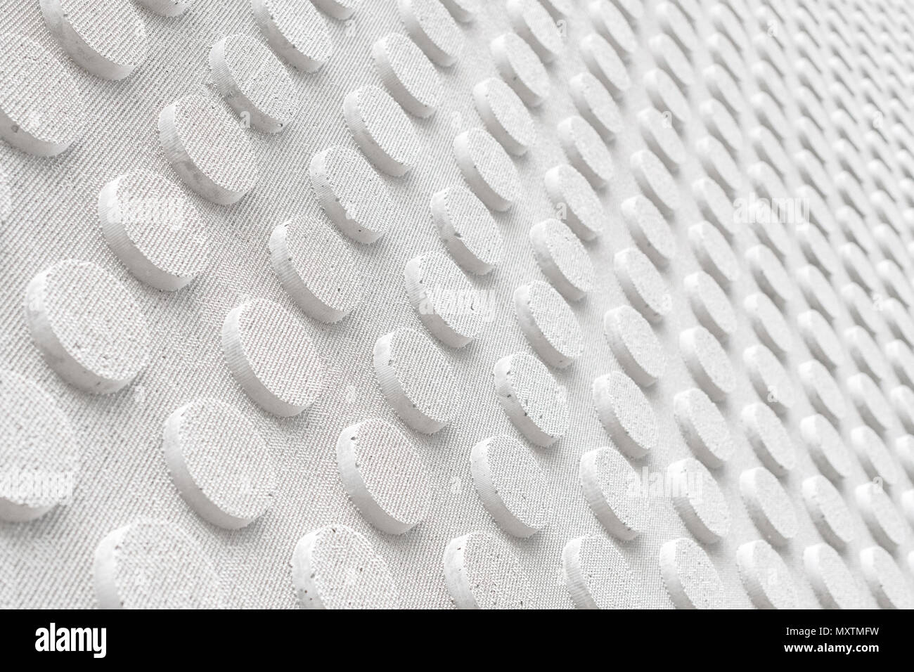 Textured wall in symetrical circular embossed shapes repeating, light ...