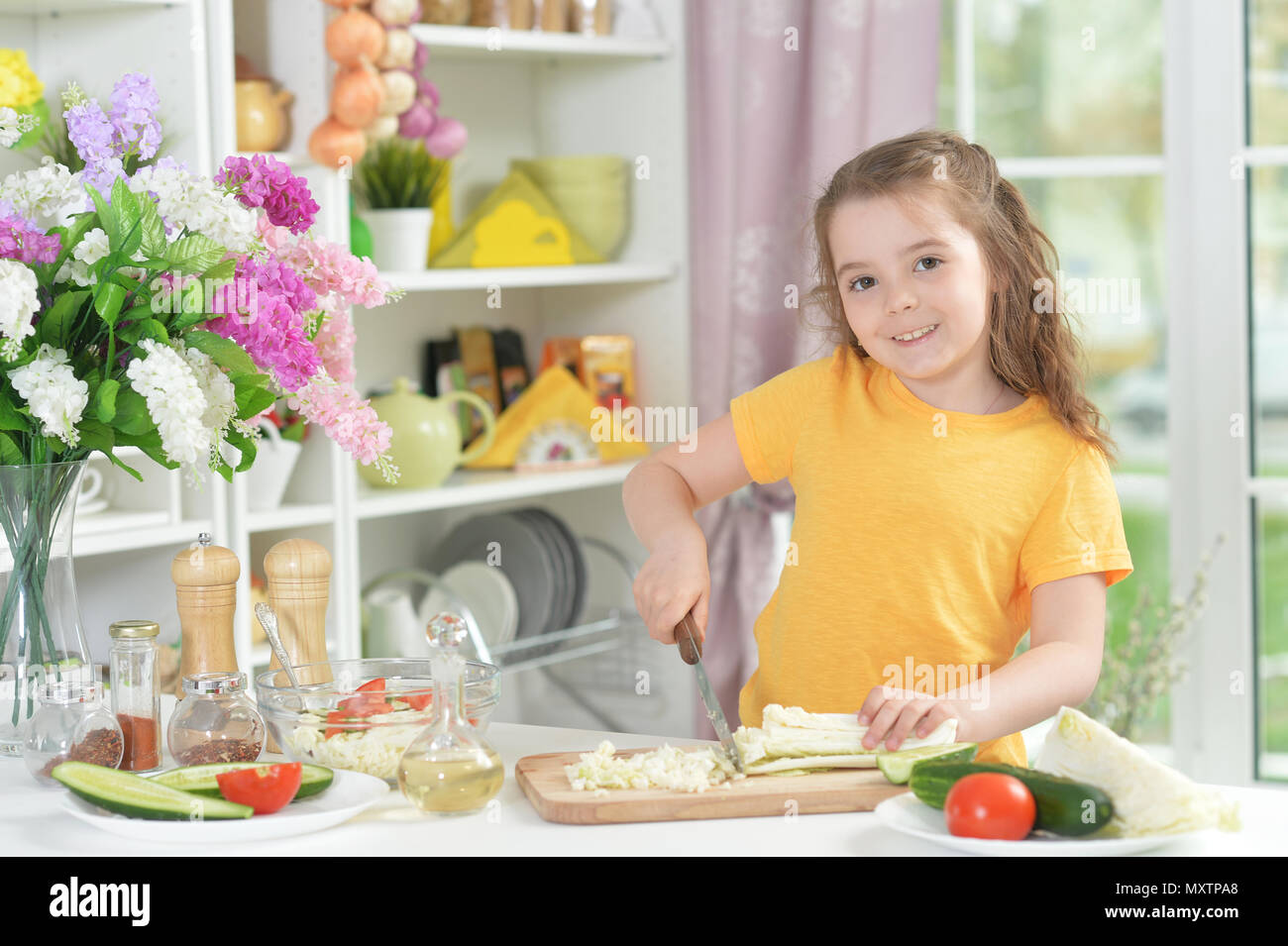 Funny little girl cooking Stock Photo - Alamy