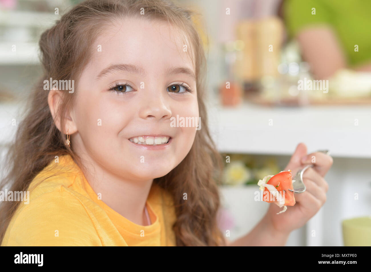 Cute girl eating delicious fresh salad Stock Photo - Alamy