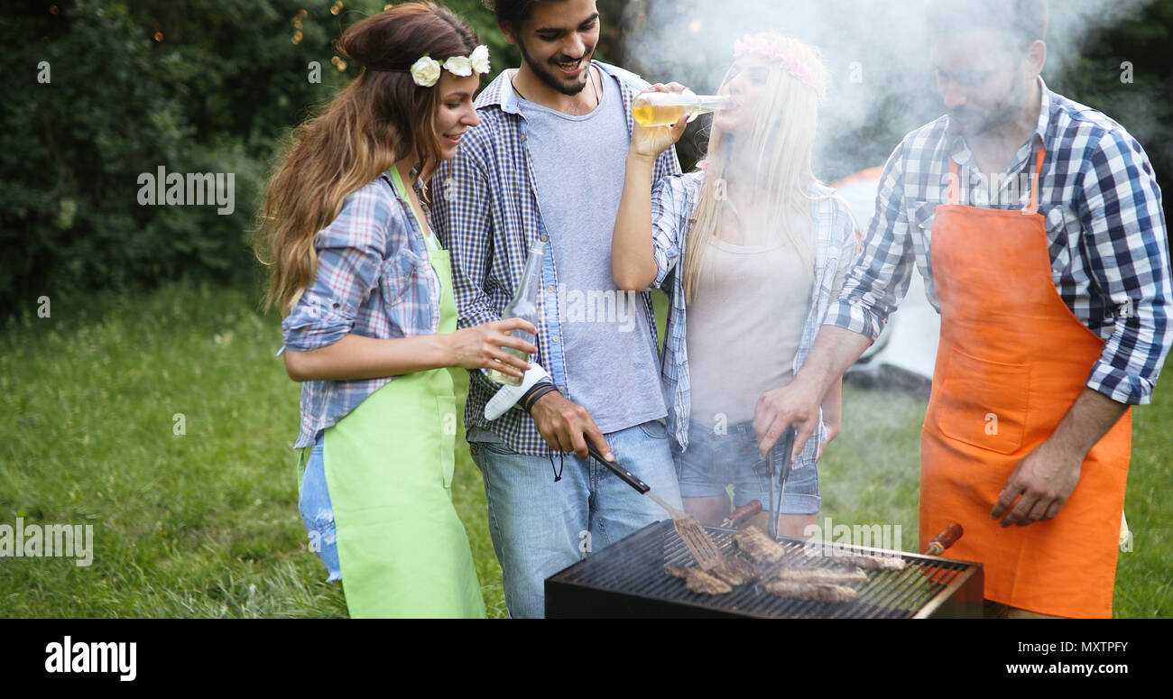 Happy people having camping and having bbq party Stock Photo - Alamy