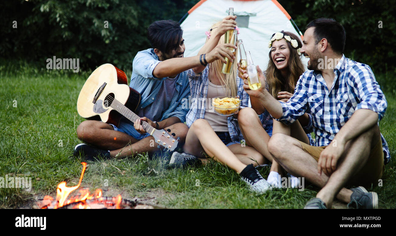 Friends having bonfire party Stock Photo - Alamy