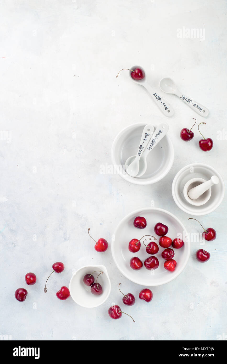 Minimalist cooking concept with red cherries and porcelain baking ...