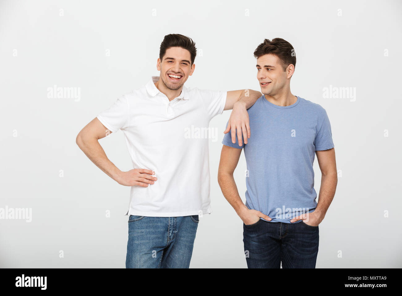 Two handsome men fellas 30s wearing casual t-shirt and jeans smiling ...