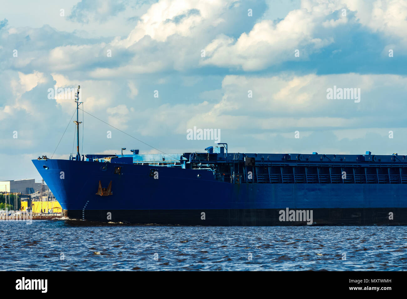 Merchandise import. Large blue cargo ship moving to Riga port Stock ...