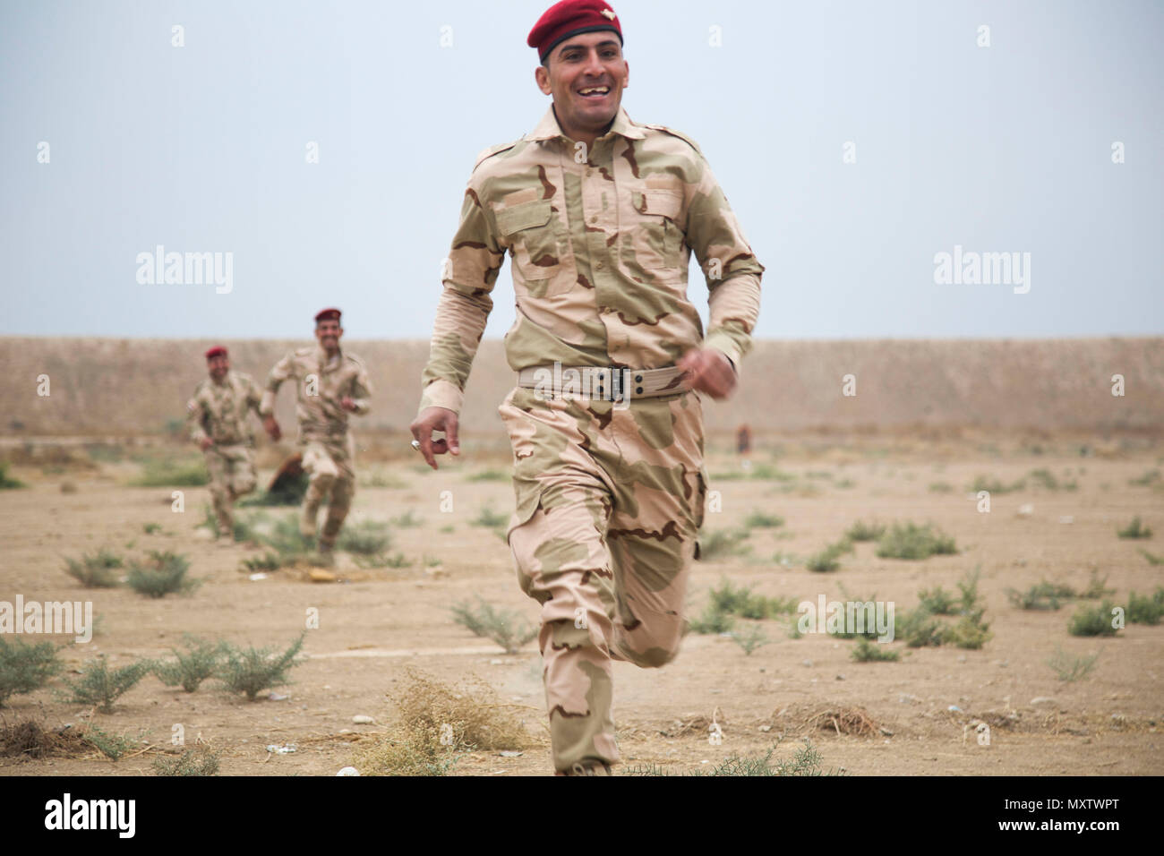 Iraqi soldiers from the Iraqi Army 60th Brigade race to raise their ...